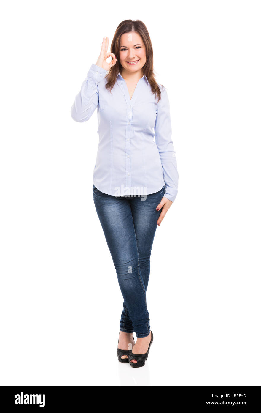 Beautiful woman smiling and doing a ok signal with her hand, isolated ...