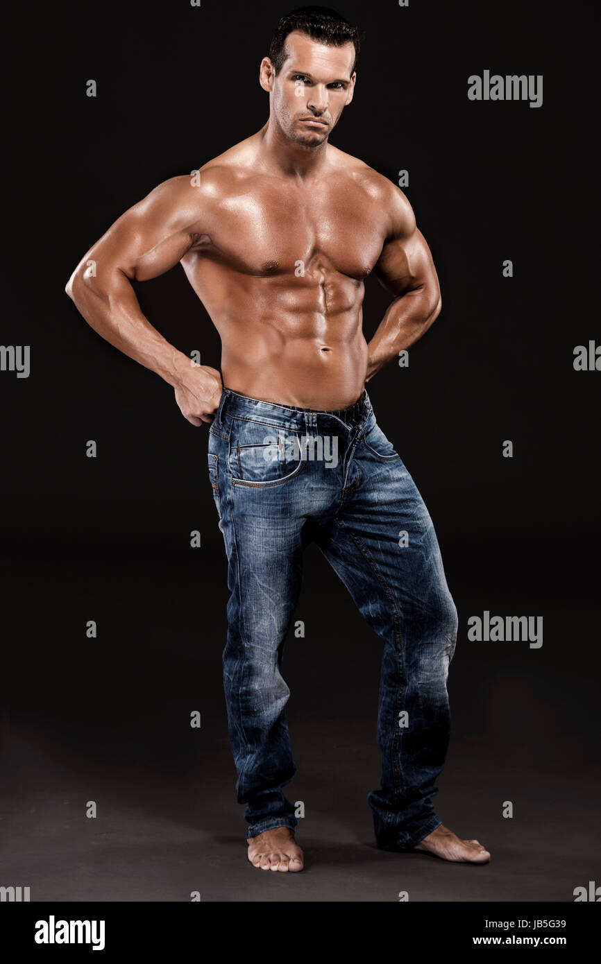 Muscle man posing in studio, isolated over a white background Stock ...