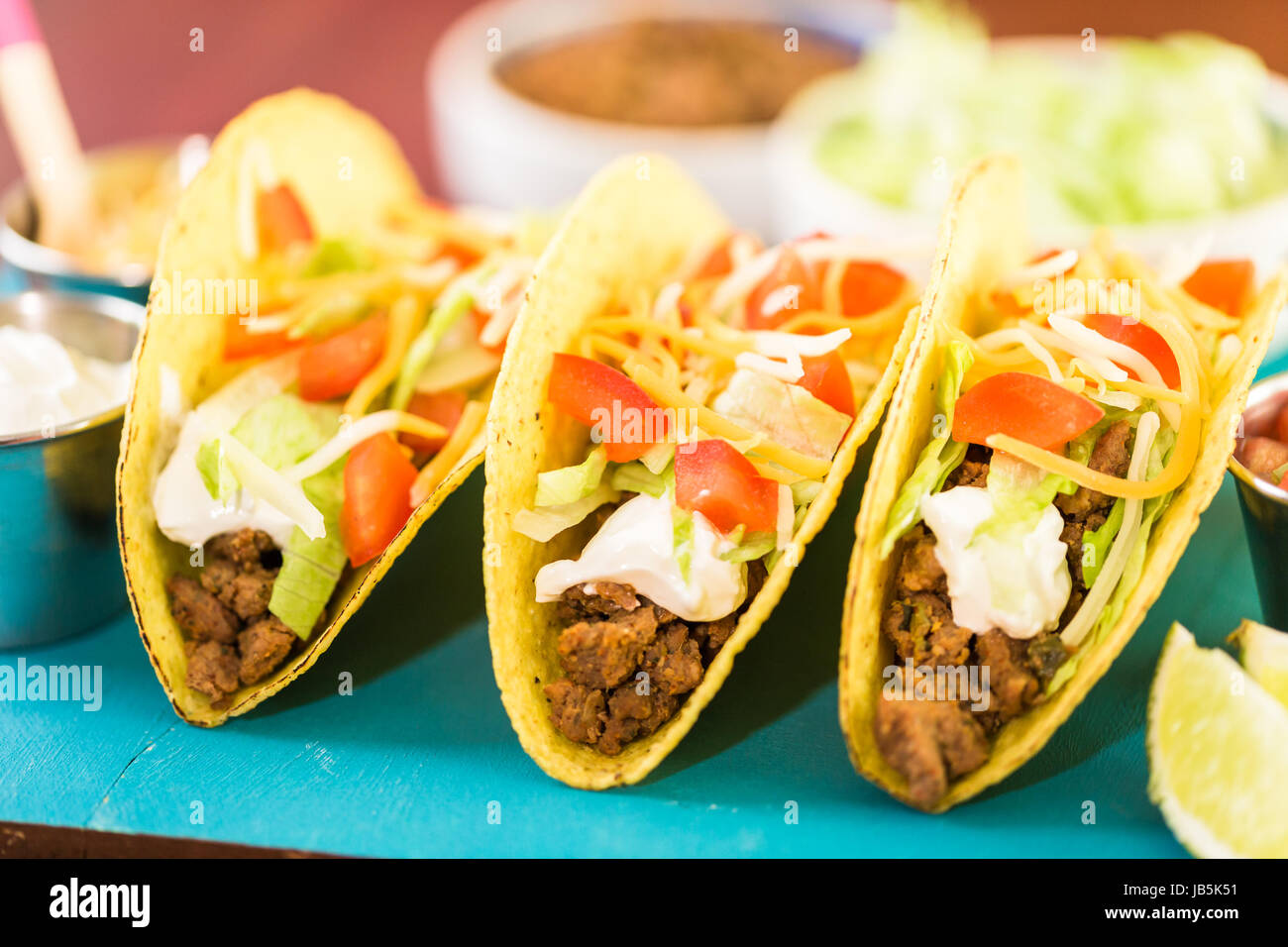 Fresh beef tacos in hard yellow corn taco shell with sour cream and ...