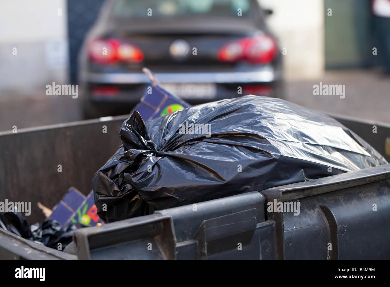 Close up picture of a garbage bin and a car on a residential area Stock ...