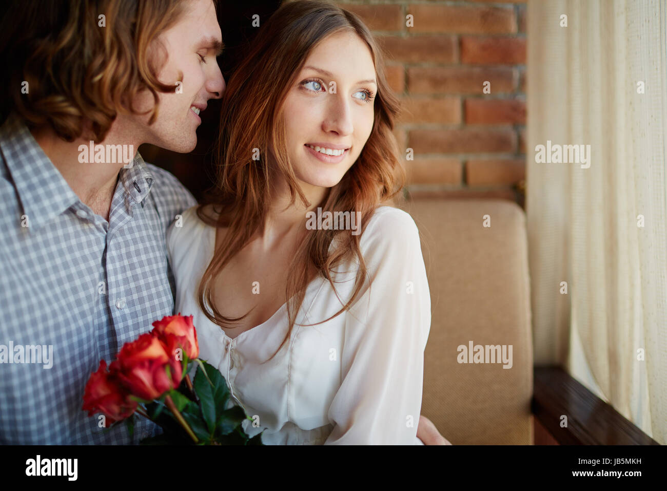 Portrait of amorous young man embracing his sweetheart Stock Photo - Alamy