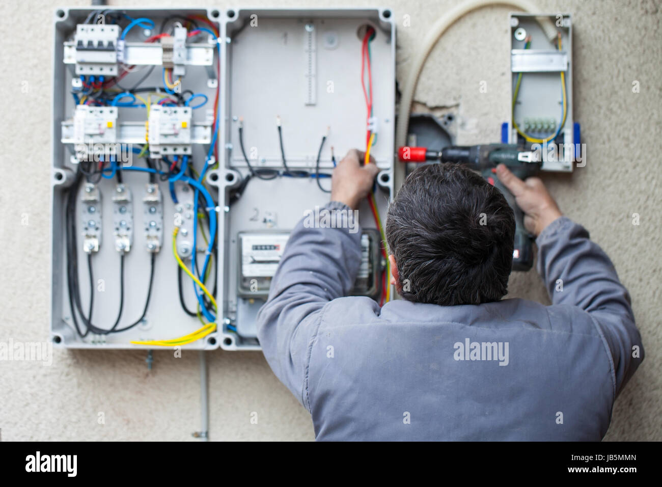 Picture of an electrician fixing an electric fuse at home Stock Photo ...