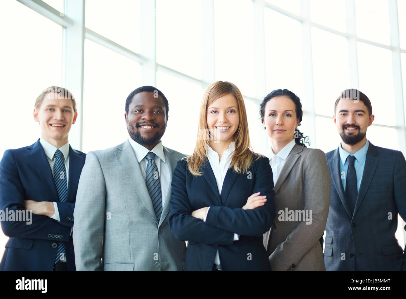 Group of business partners looking at camera with smiles, pretty leader ...