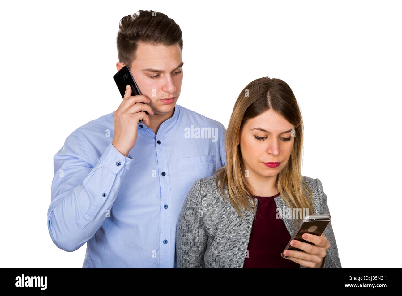 Picture of a young attractive couple being on their phones on isolated ...