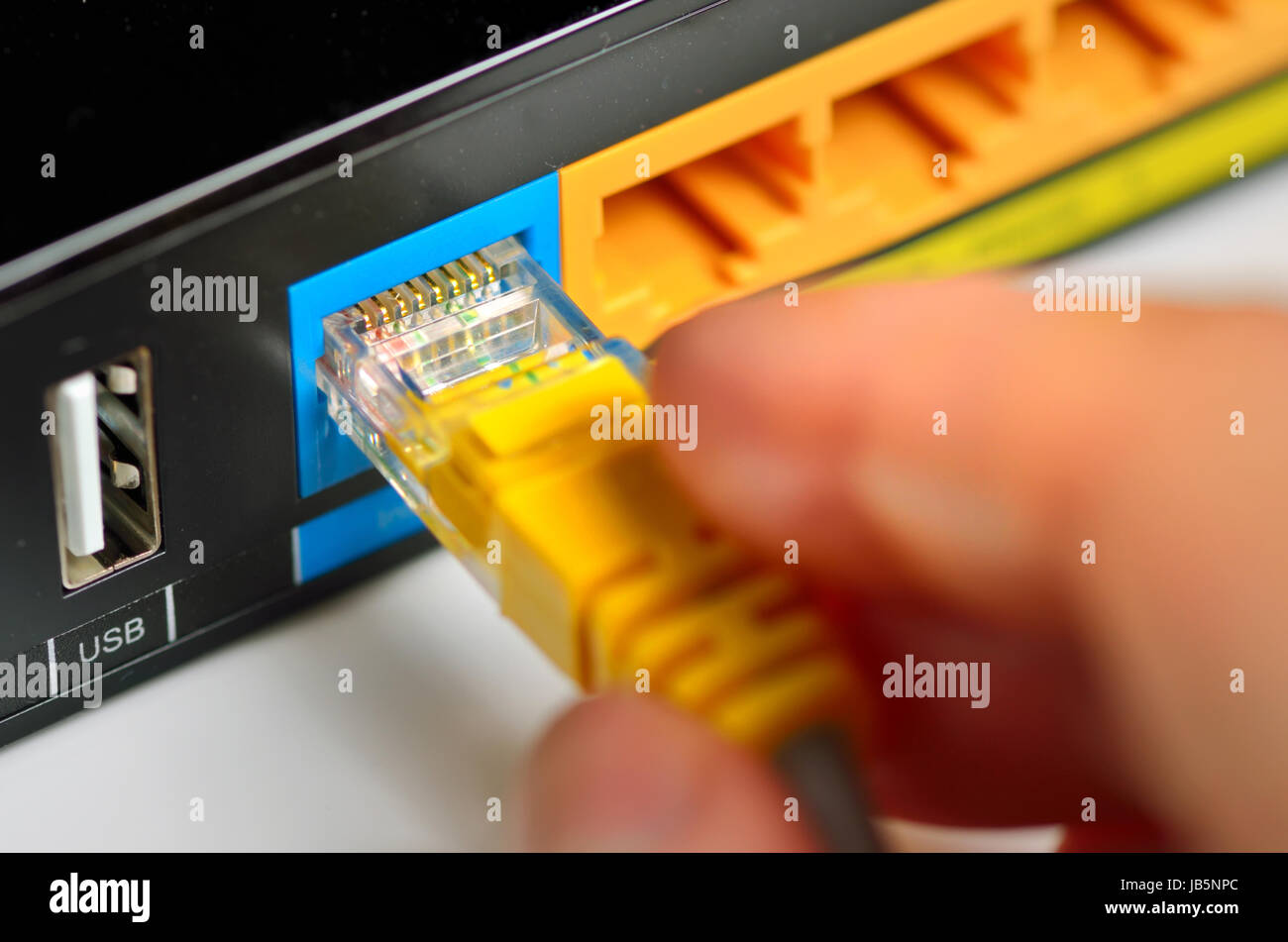 Connecting network plug on router Stock Photo - Alamy