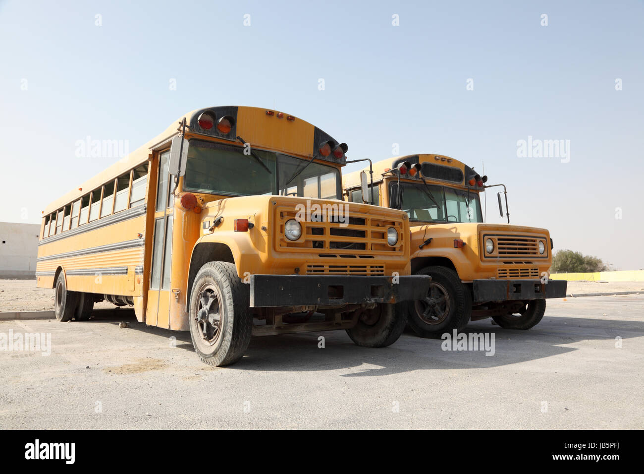 Two yellow school buses in a parking lot. Doha, Qatar, Middle East ...