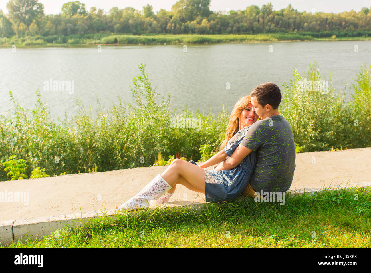 Portrait of happy girl hugging her boyfriend outside Stock Photo - Alamy