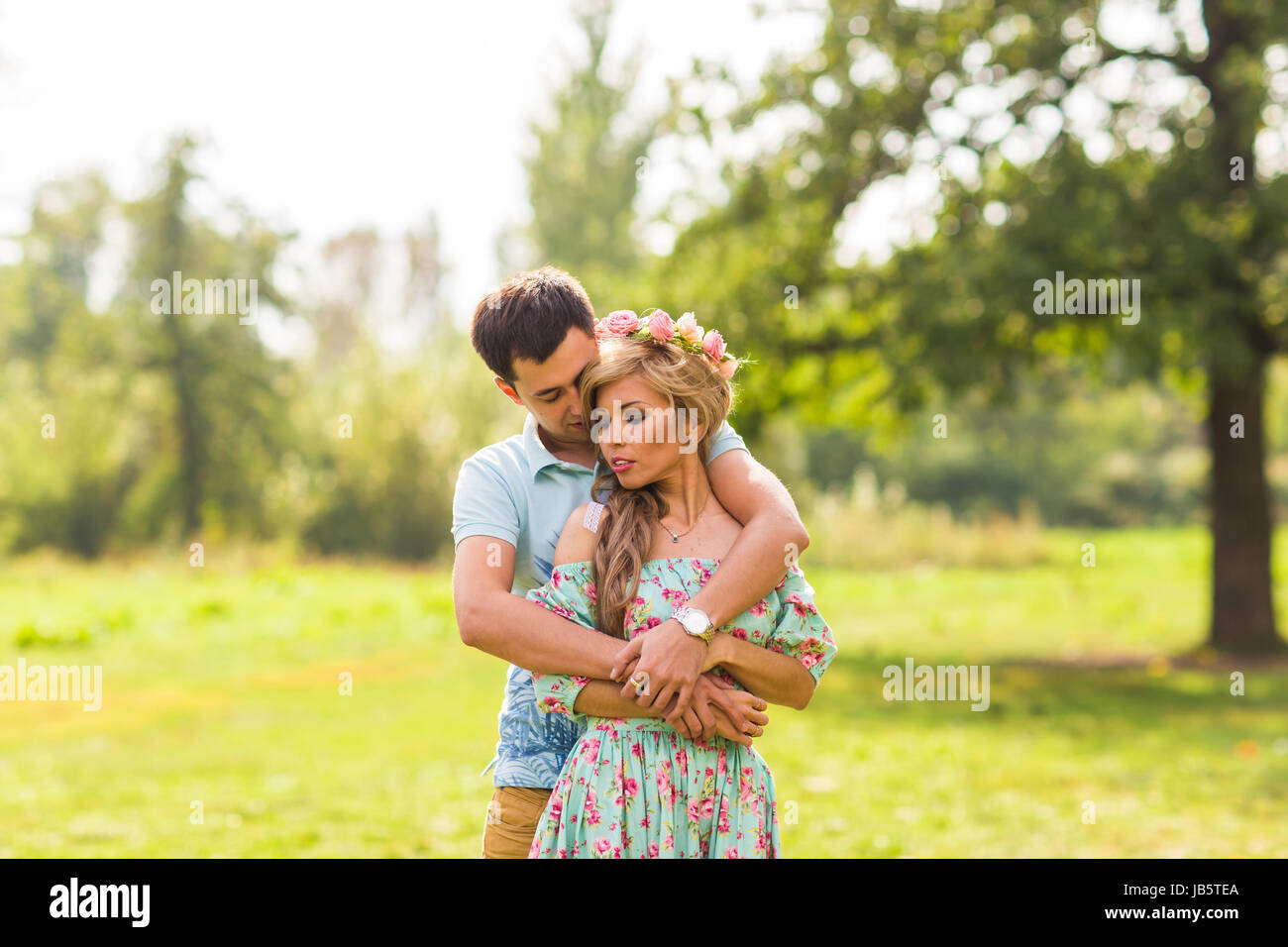 Young couple in love hug each other in nature Stock Photo - Alamy