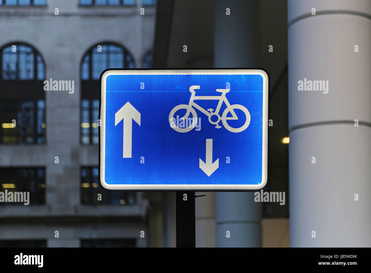 Illuminated blue sign for bicycle lane Stock Photo - Alamy