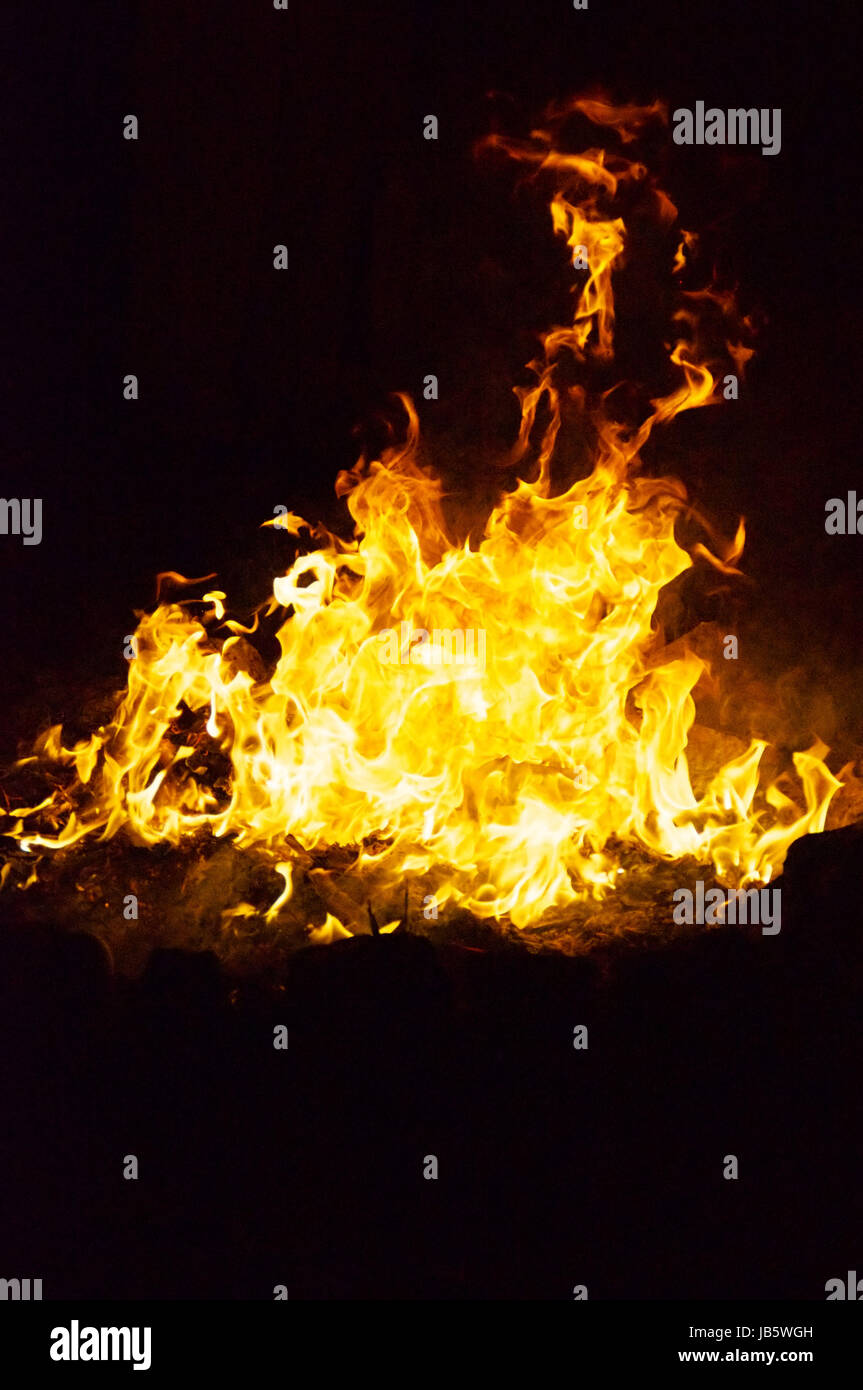 Flames and smoke fill this image of a ceremonial fire during a mayan ...