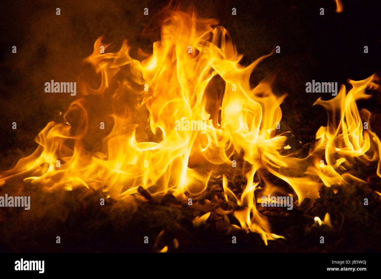 Flames and smoke fill this image of a ceremonial fire during a mayan ...