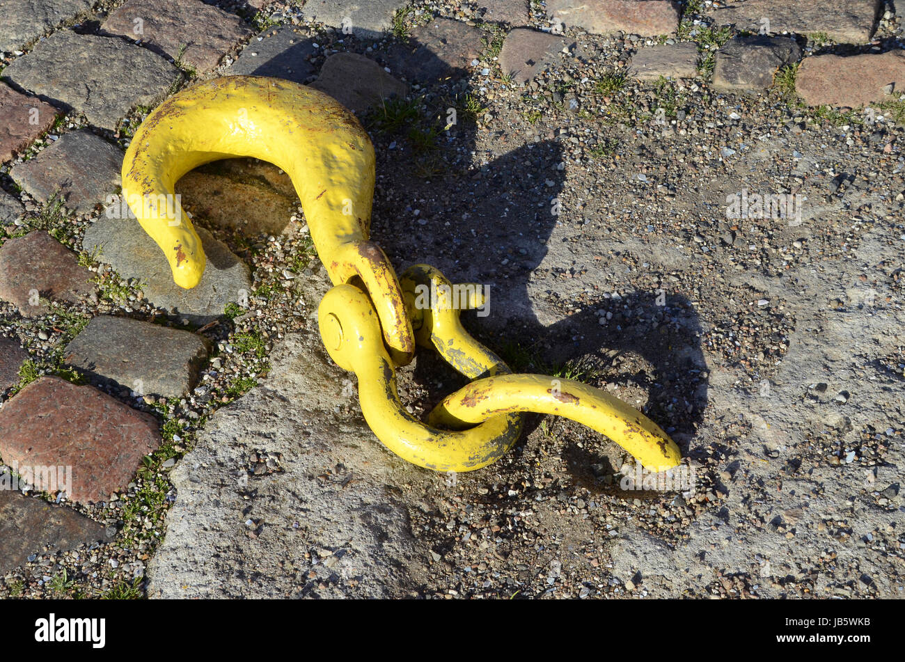 Large yellow anchoring hook at a harbor Stock Photo - Alamy