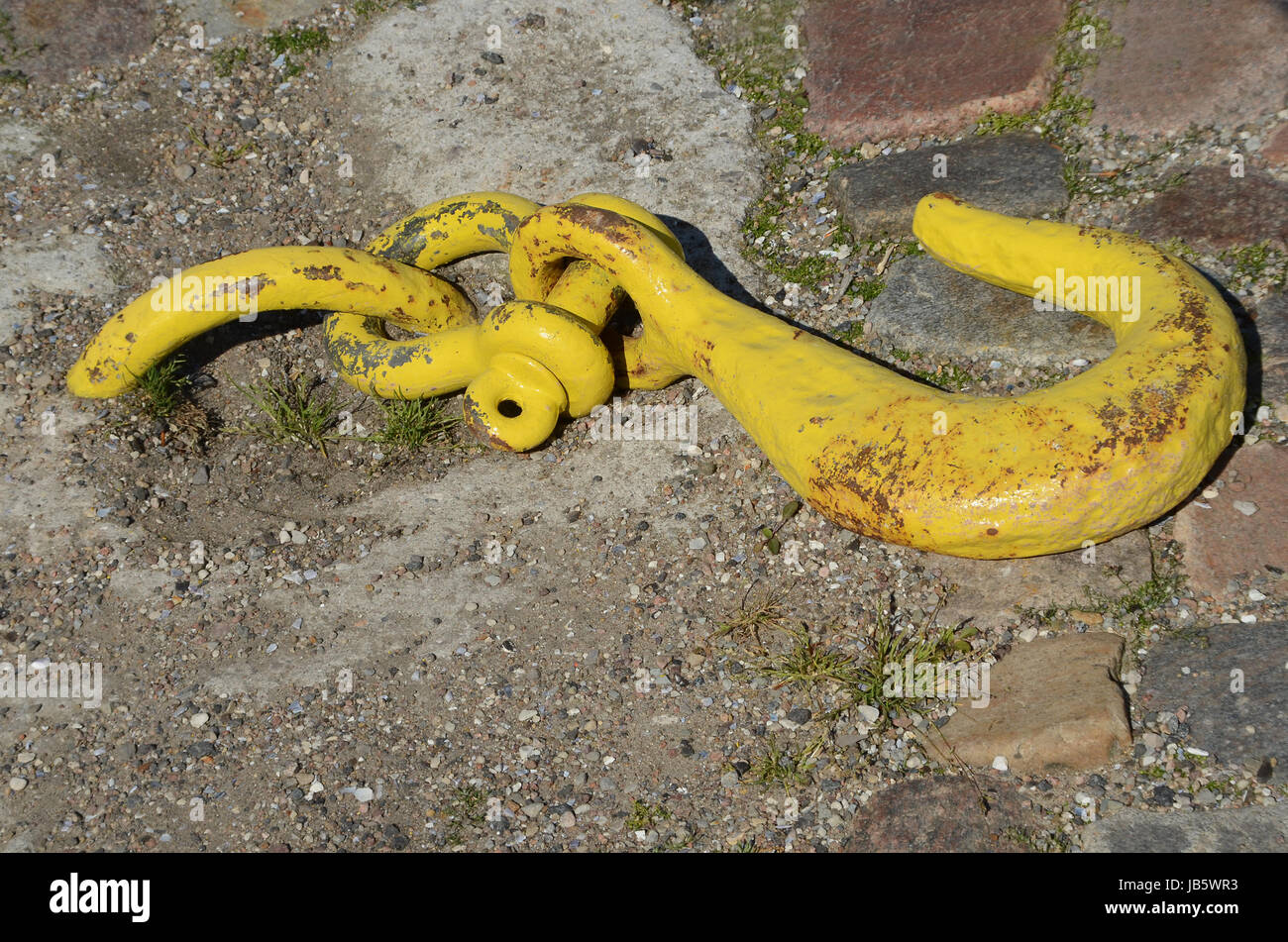 Large yellow anchoring hook at a harbor Stock Photo - Alamy