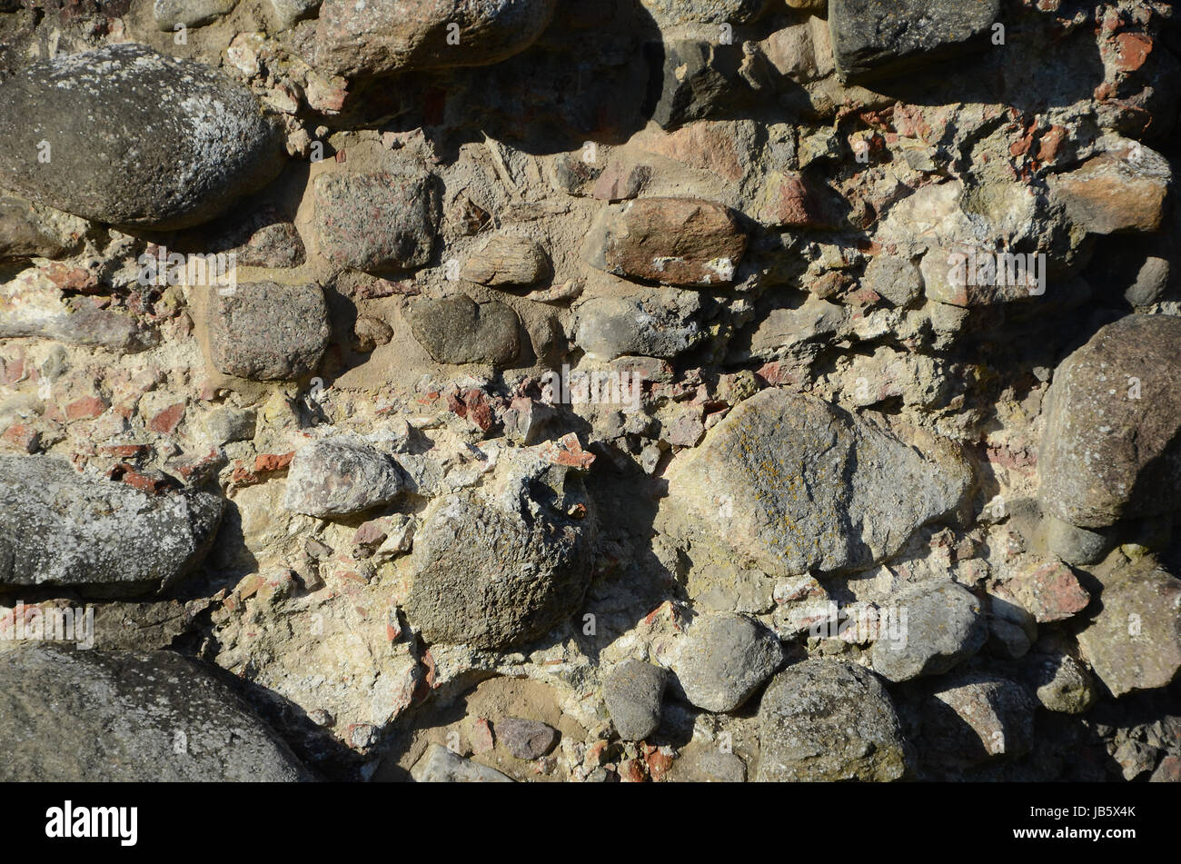 Old weather beaten stone wall of a ruin Stock Photo - Alamy