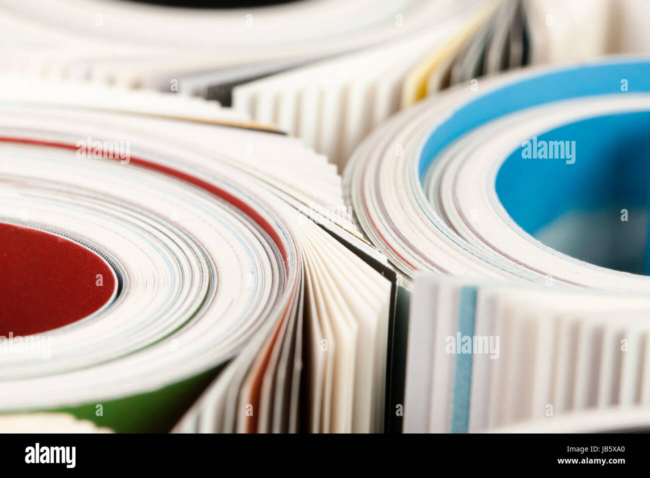 Stack of color magazines on white background Stock Photo - Alamy