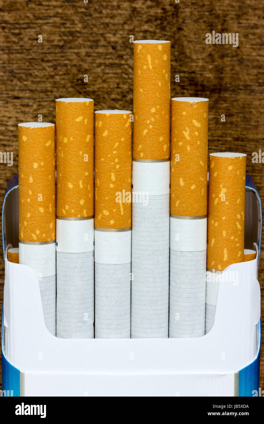 Open pack of cigarettes on the wooden table Stock Photo - Alamy