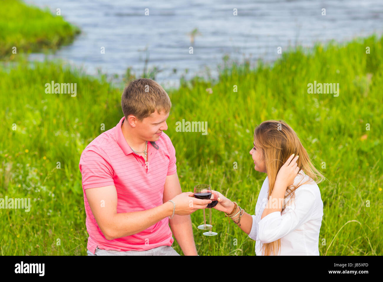Beautiful love couple having romantic picnic outdoors on summer sunny ...