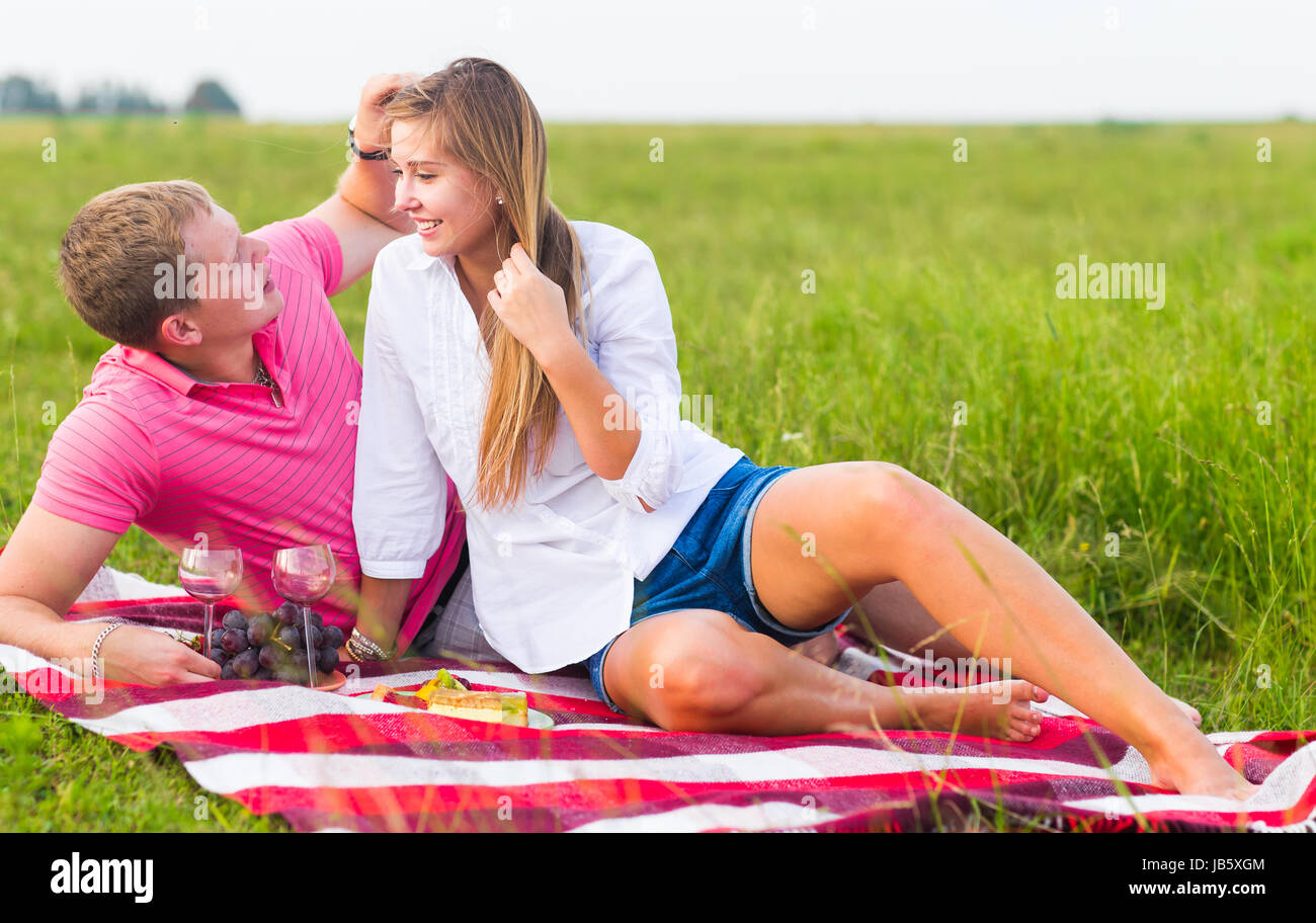 Beautiful love couple having romantic picnic outdoors on summer sunny ...