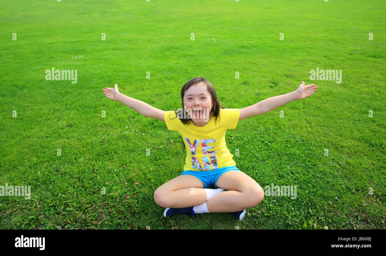 Young girl on the background of green grass Stock Photo - Alamy