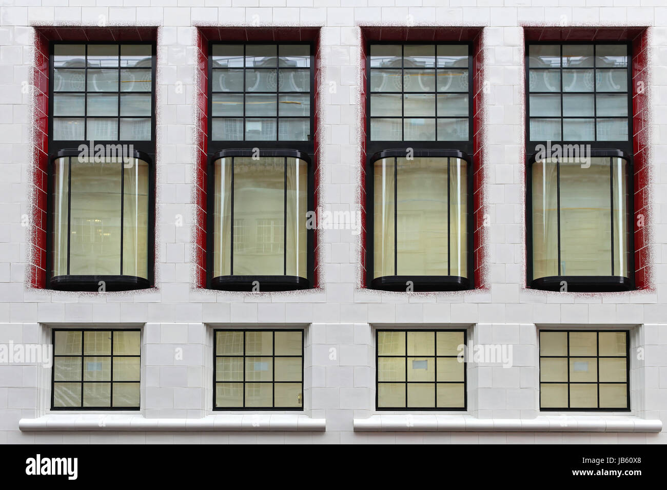 Closed windows exterior on white facade building Stock Photo - Alamy