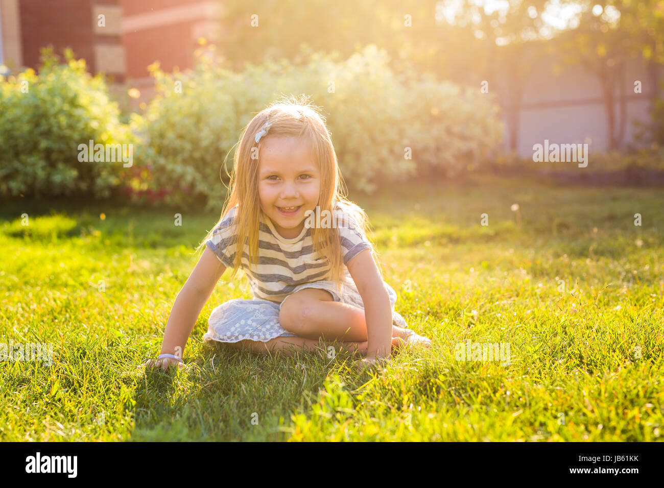 happy child girl playing on meadow in summer in nature Stock Photo - Alamy