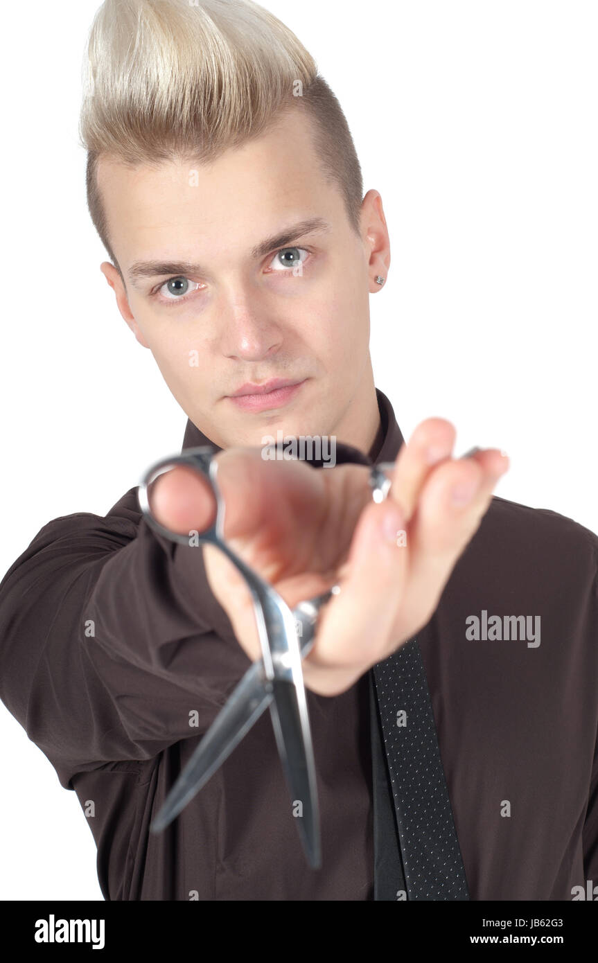 Portrait of stylish man with pair of scissors in studio isolated on ...