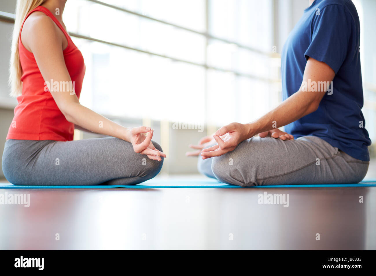 Woman and man meditating face to face Stock Photo - Alamy