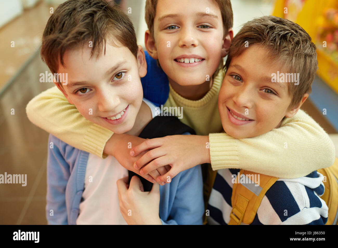 Portrait of three happy embracing boys Stock Photo - Alamy