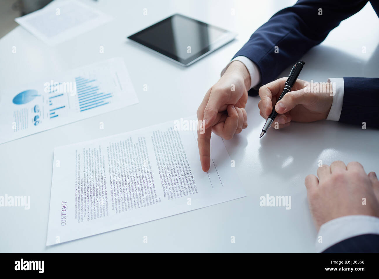 Two businessmen while signing a contract Stock Photo - Alamy