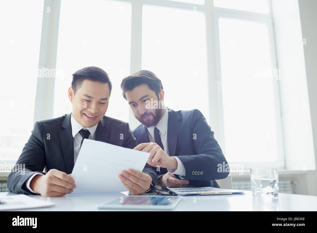 Two managers discussing contract in meeting room Stock Photo - Alamy