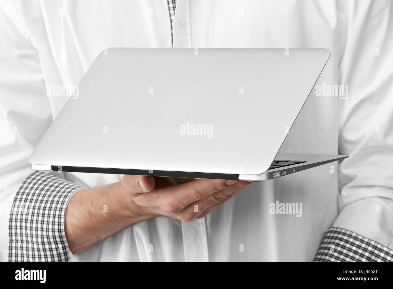Hand holding a laptop Stock Photo - Alamy