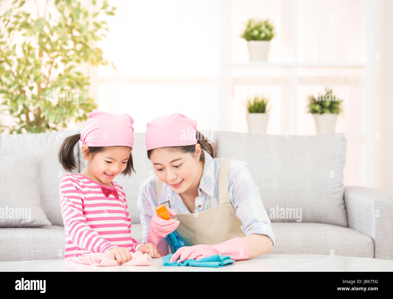 Happy family cleans the living room. Mother and daughter do the ...