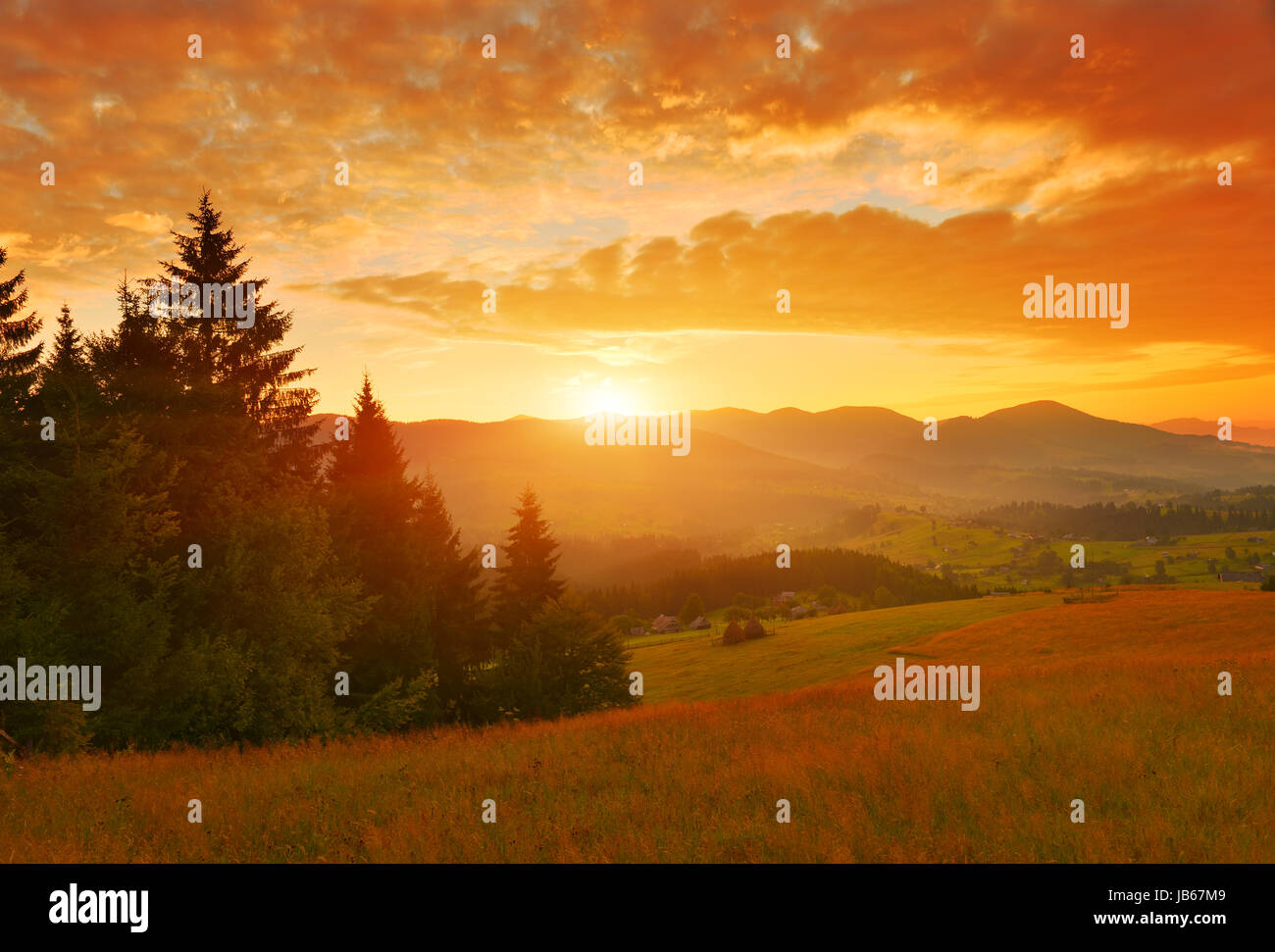 Rising sun above the summer highland Stock Photo - Alamy
