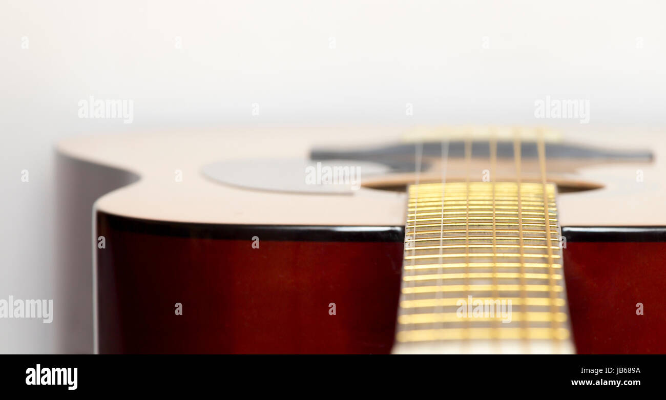 Lacquered wooden acoustic guitar close-up on a white background Stock ...