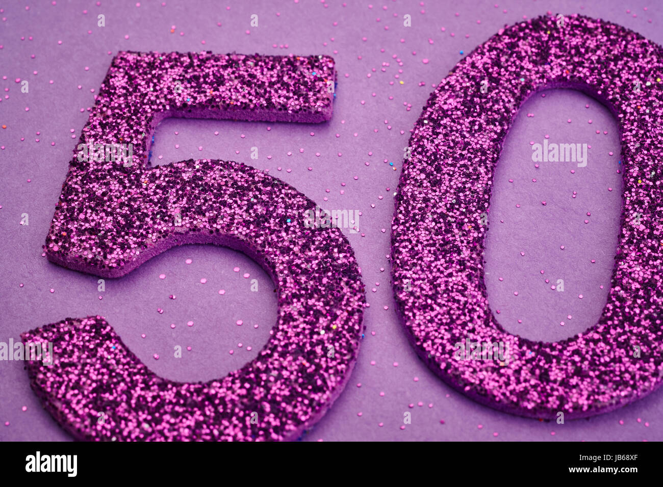 Number fifty purple color over a purple background. Anniversary ...