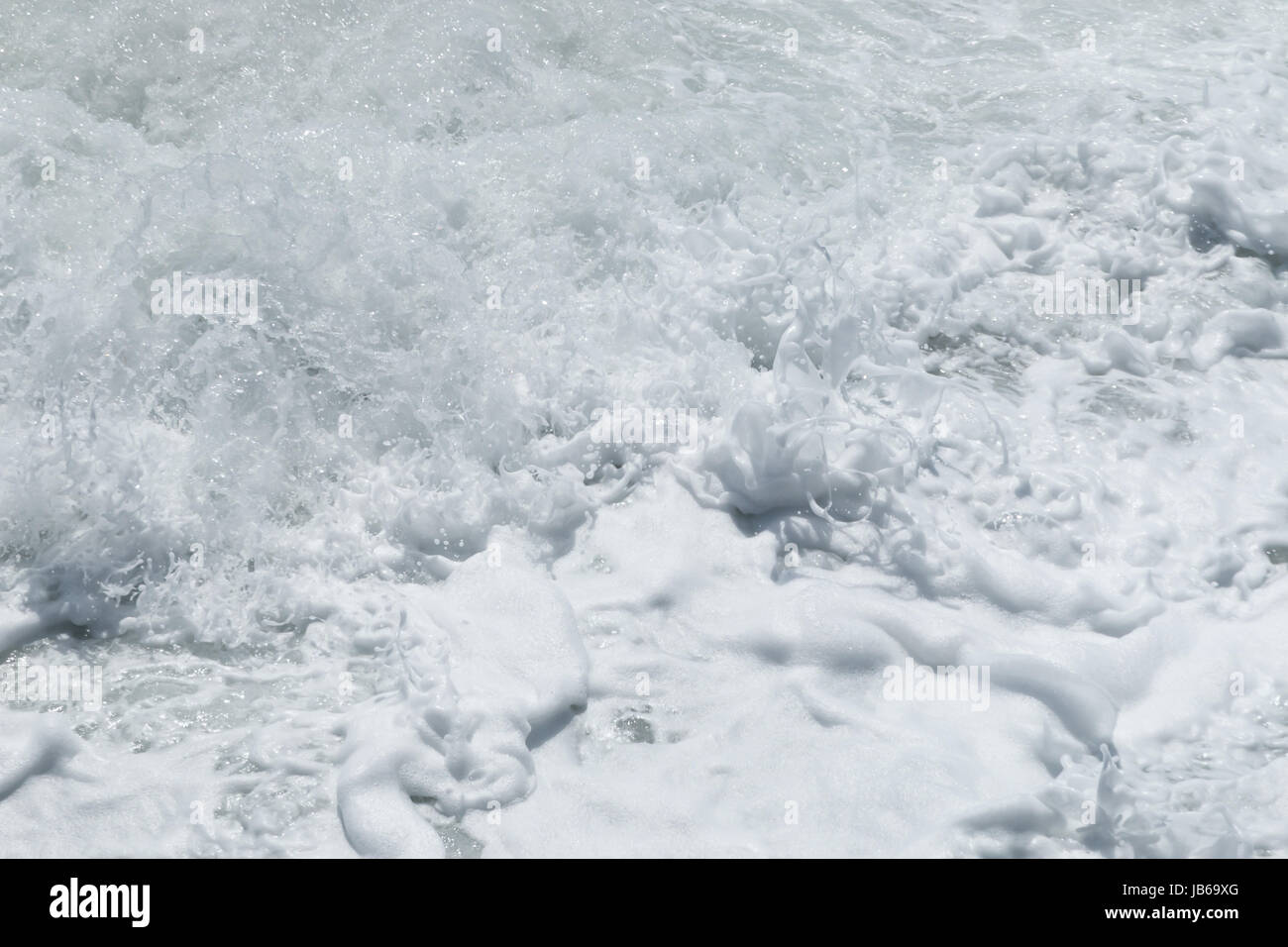 Frothy water closeup on the coastline of Cape Foulwind, on the west ...
