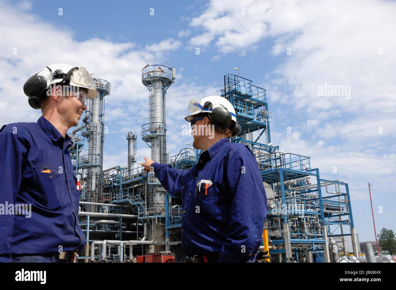 MODEL RELEASED. Two industrial workers on oil and gas refinery Stock ...