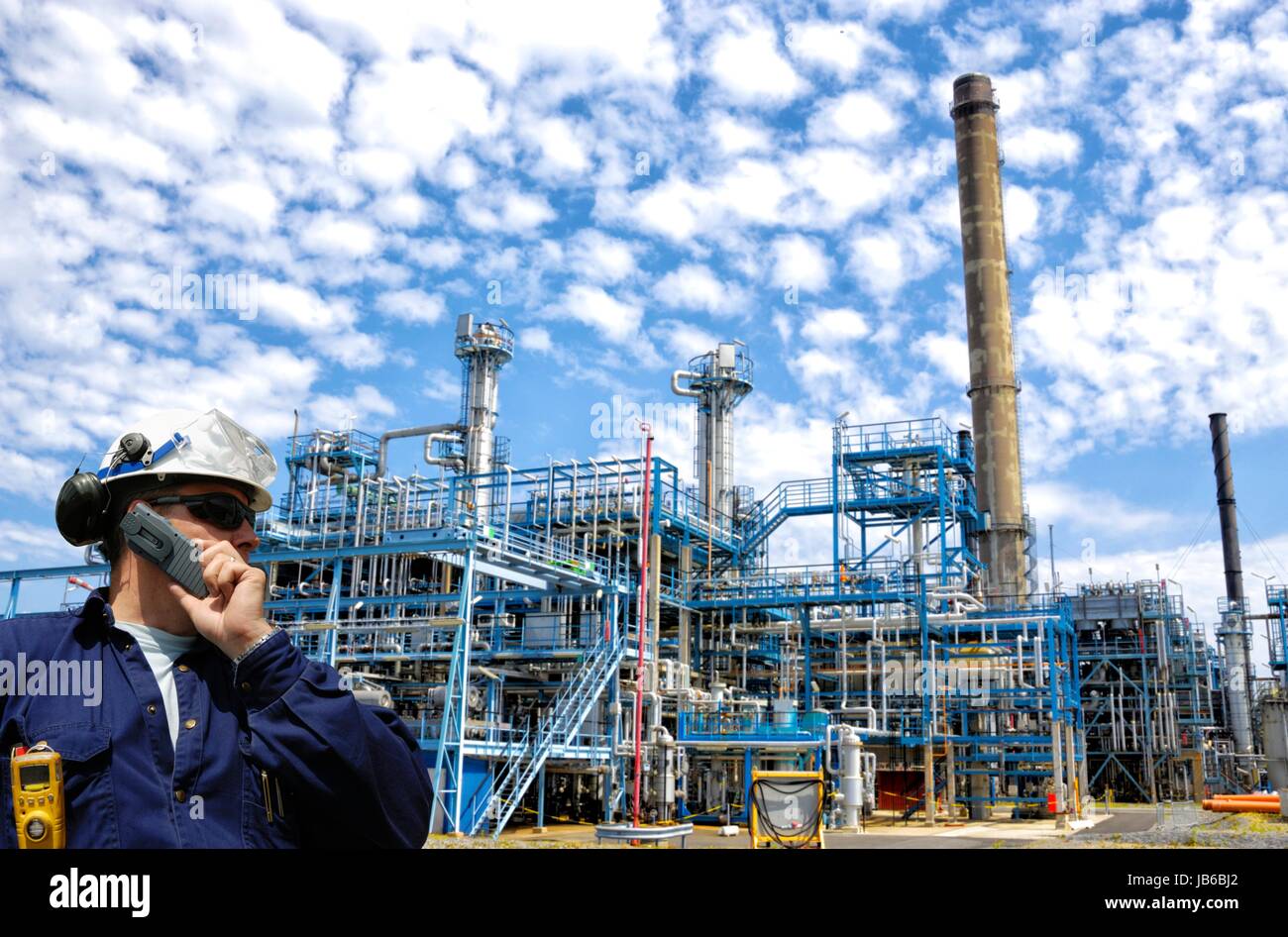 MODEL RELEASED. Industrial worker on oil and gas refinery using cell ...