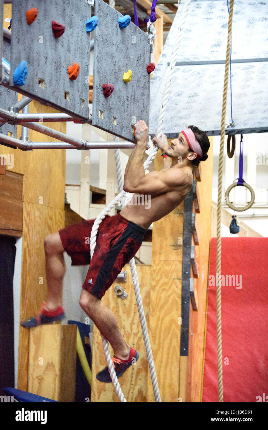 Adam rahl completing the floating hanging wall obstacle during a ninja ...