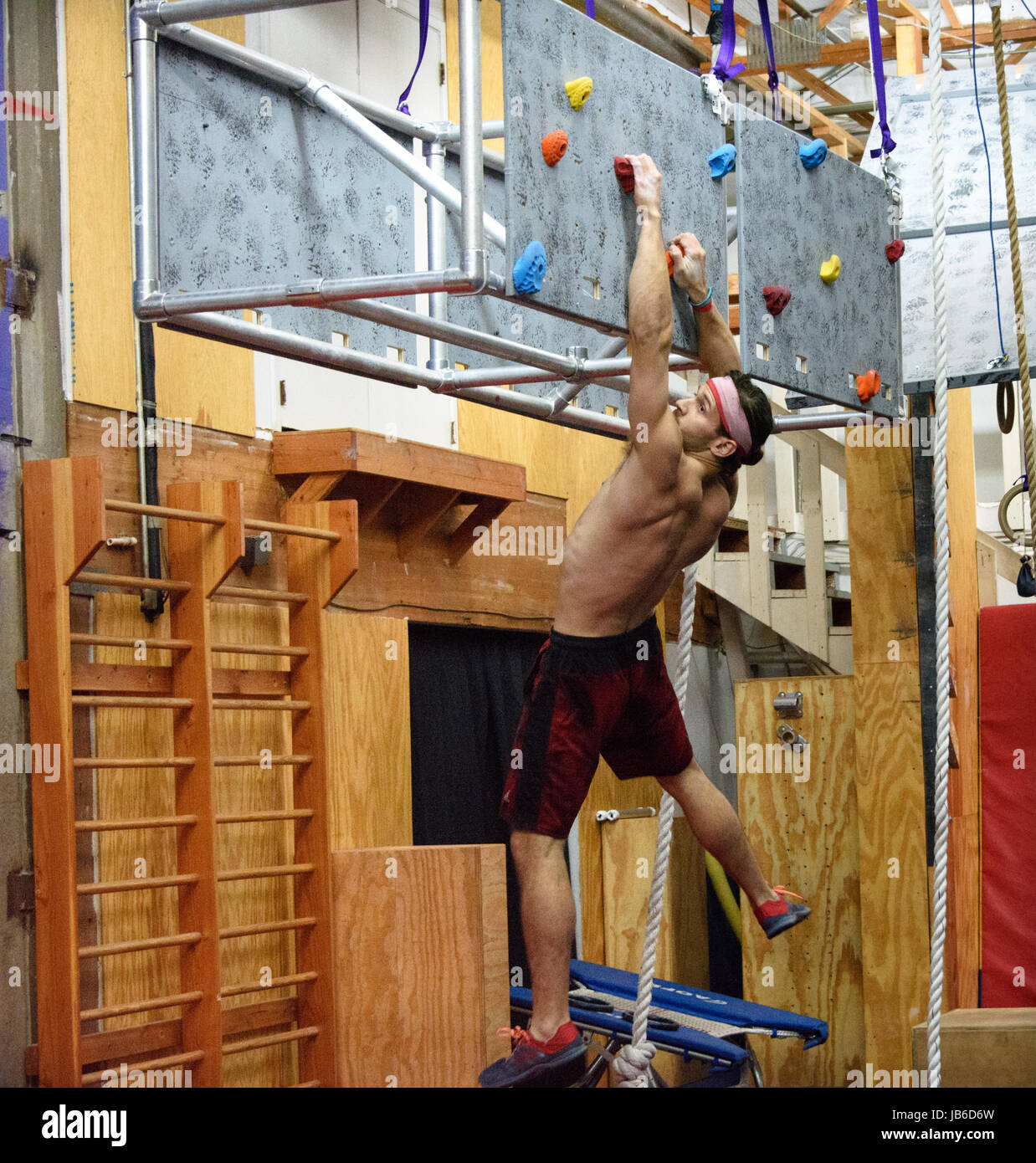 Adam rahl completing the floating hanging wall obstacle during a ninja ...