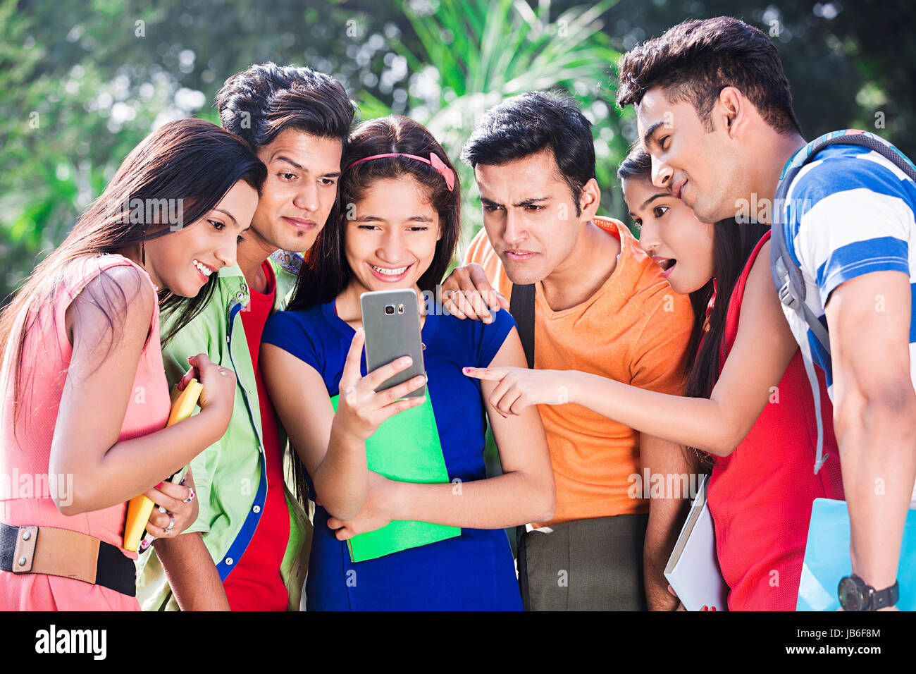 Surprised Indian Group College Students Reading Text Messaging On ...
