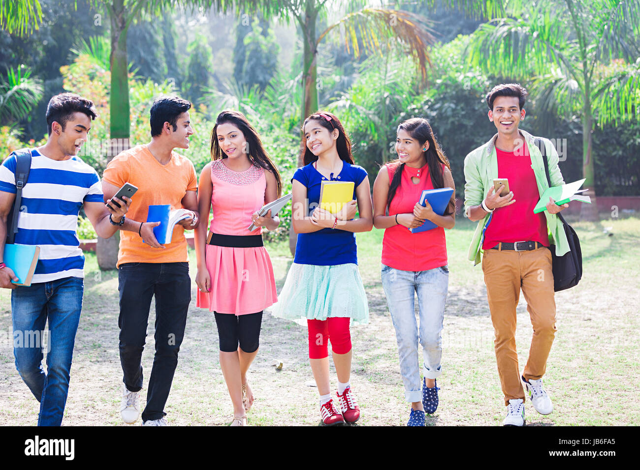 Group Indian College Friends Gossip Walking Together In Park Stock