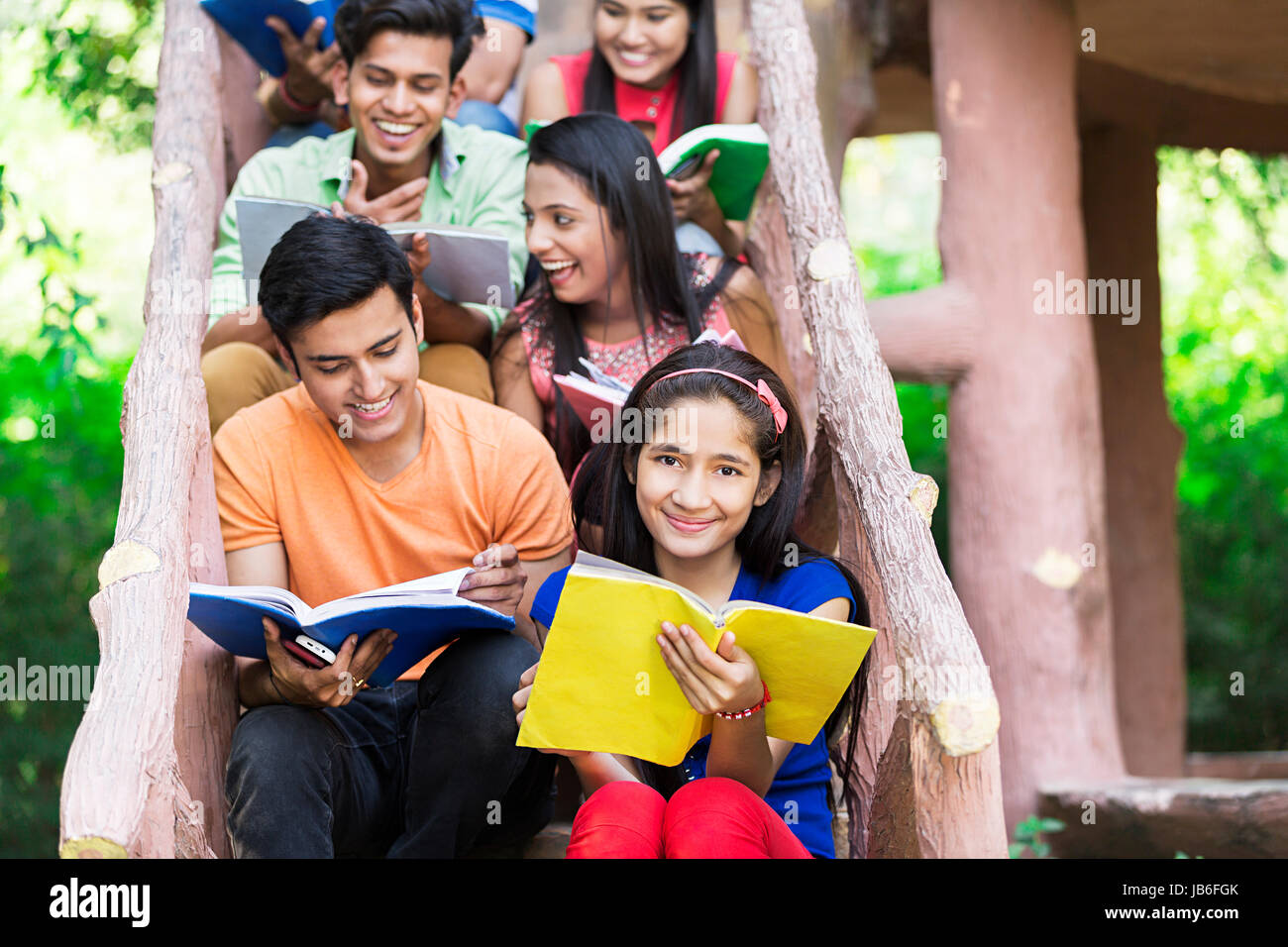 Group College Girls And Boys Students Read Book Study Exam Preparing In ...