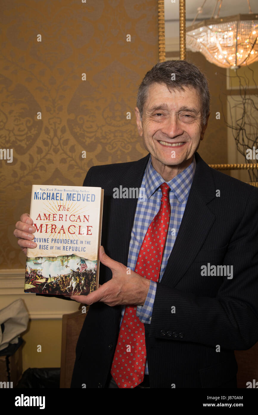 Michael Medved, talk show host & author, The Michael Medved Show, holds a copy of his book "The ...