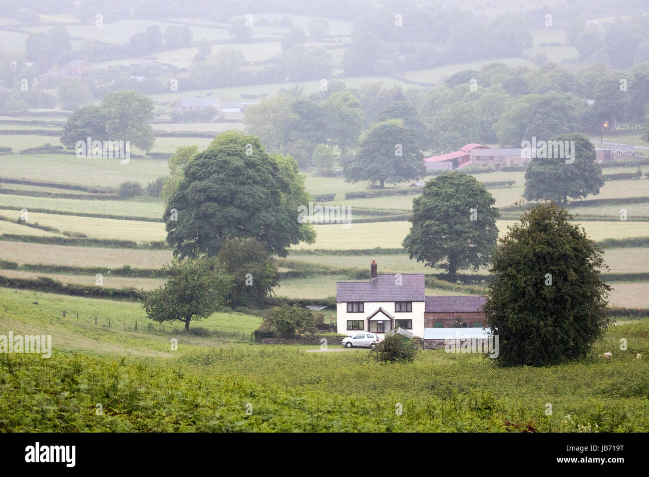 Rain begins to fall over a rural Welsh Landscape and the cottage Tan-y ...