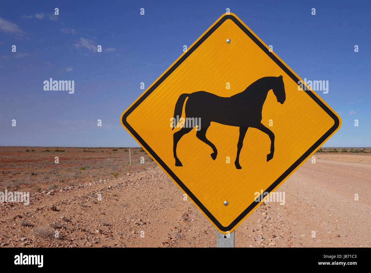 Caution sign warning horses ahead Stock Photo - Alamy