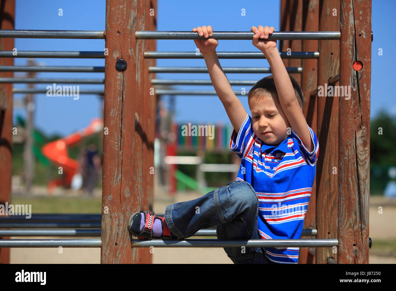child in playground kid in action boy play on leisure equipment ...