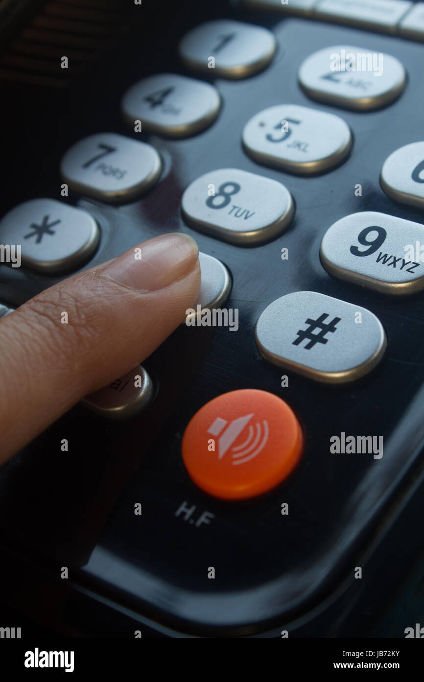 black telephone with hand press the button Stock Photo - Alamy