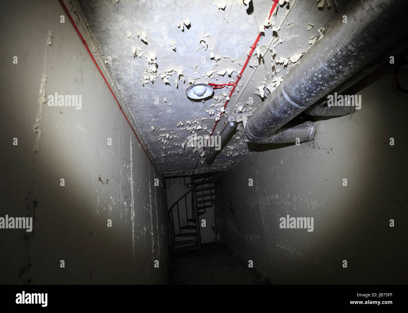 Corridor with spiral staircase in a corridor in the underground bunker ...