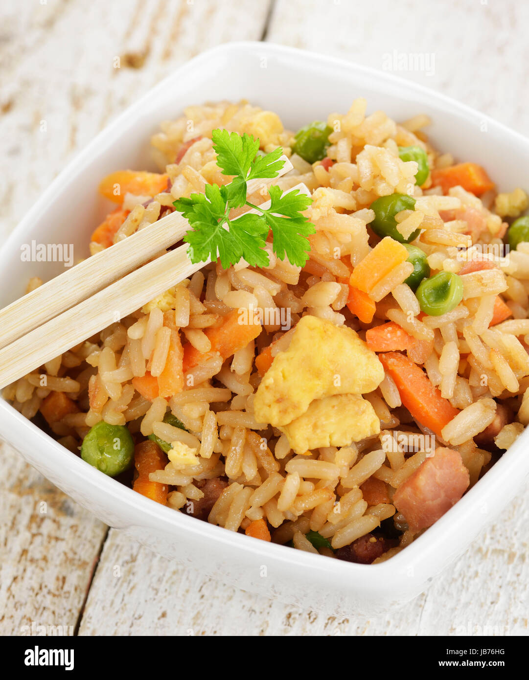 Rice With Chicken And Vegetables In A White Bowl Stock Photo - Alamy
